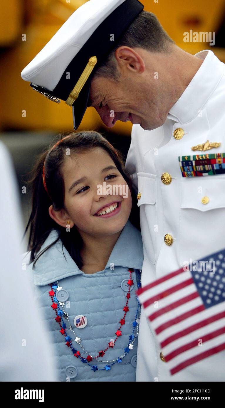 Julia Recker, 9, embraces her father, Chief Warrent Officer Steven ...