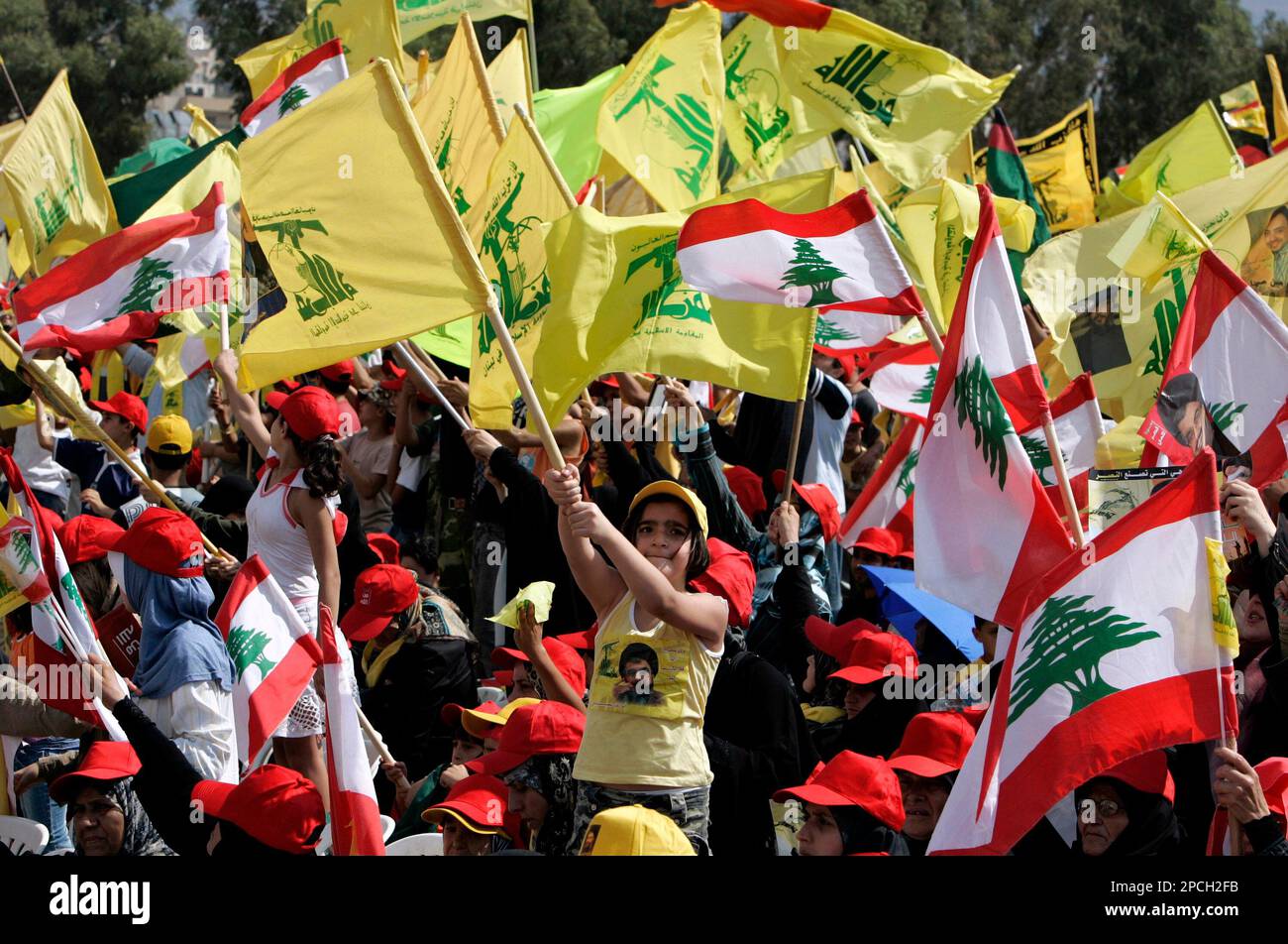 Hezbollah supporters wave Lebanese and Hezbollah yellow flags during a ...