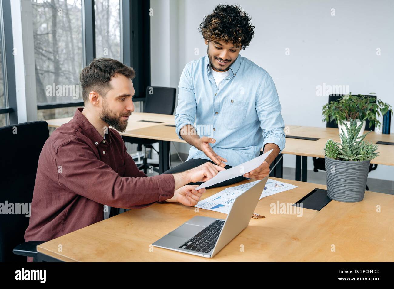 Two confident stylish male business colleagues of different ethnicity ...