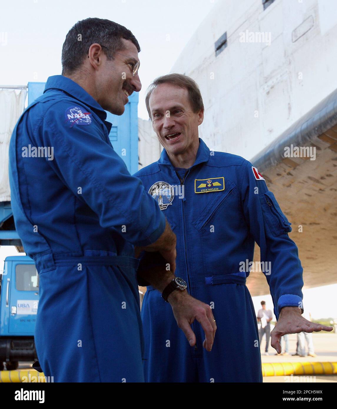 Space Shuttle Atlantis Mission Specialist Daniel Burbank, left, talks ...