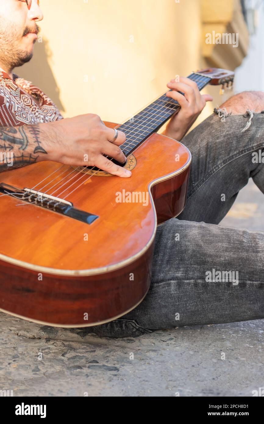 Street musician's hands playing guitar in the street Stock Photo - Alamy