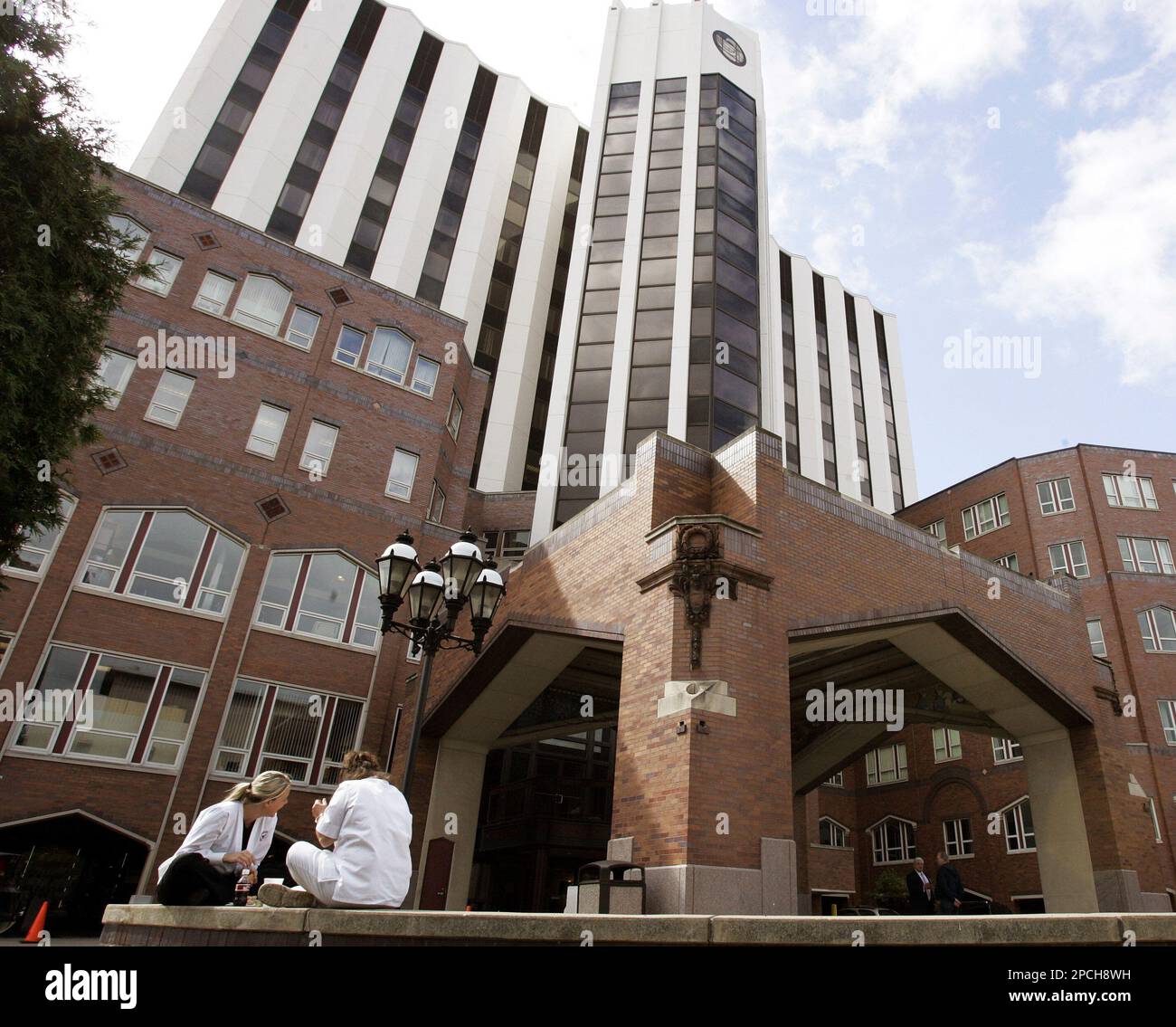 Student nurses sit outside the main entrance to Mercy Hospital ...