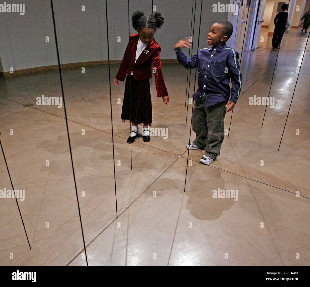 Eliza, 6, left, and Christopher Hamilton, 5, beckon to their mother ...