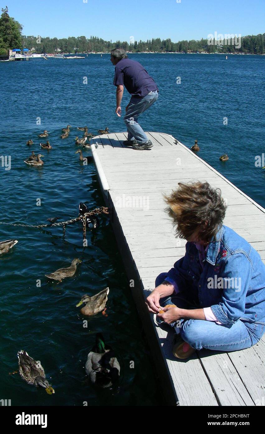 Connie Manning, right, and her brother, Dan Manning, feed the ducks on ...