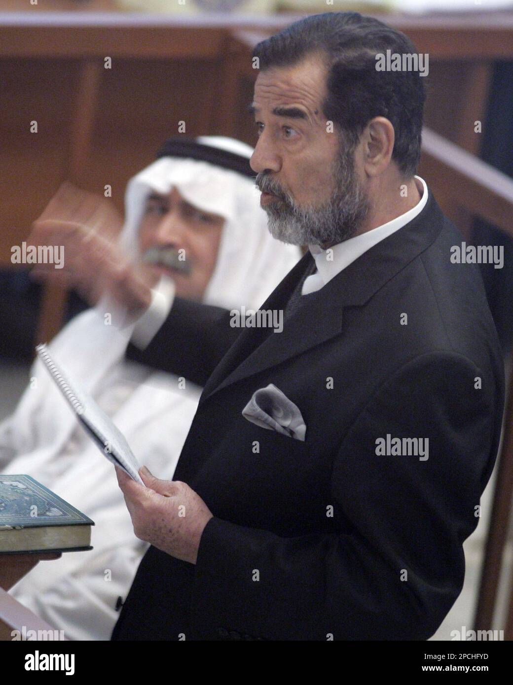 Saddam Hussein testifies during his trial on genocide charges in the ...
