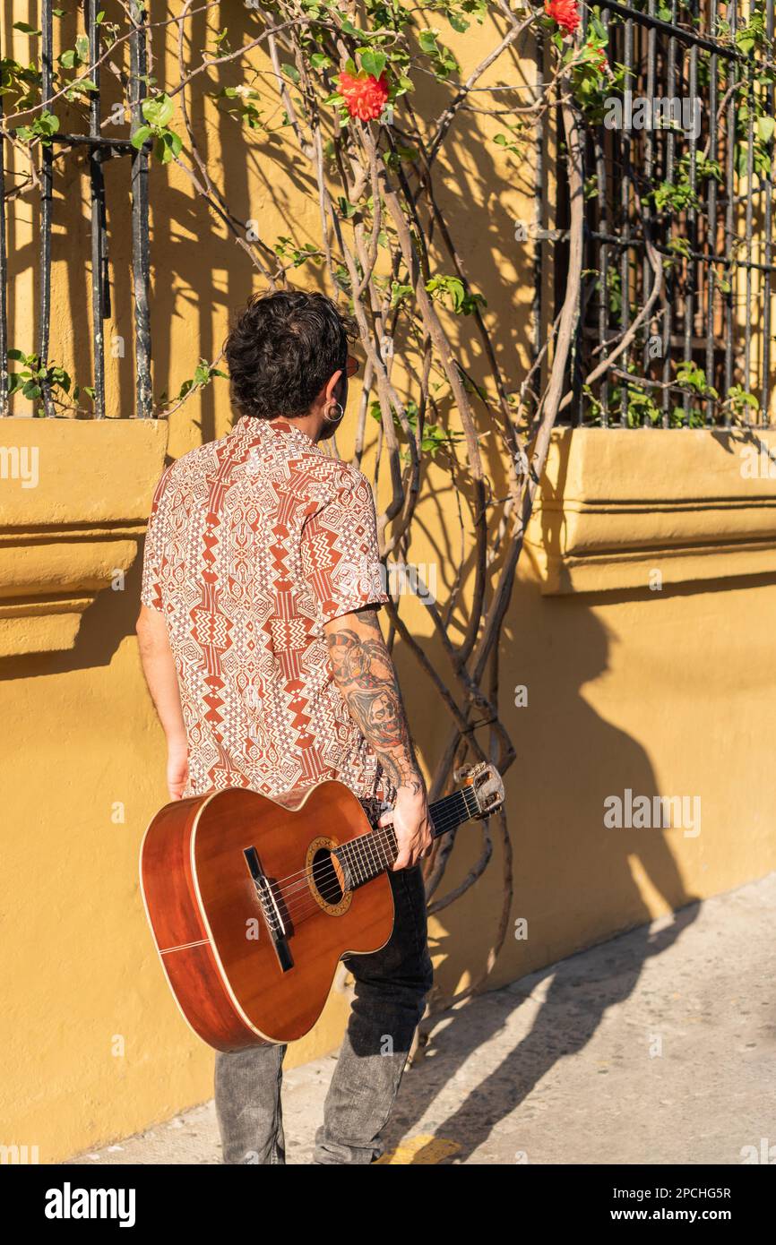 Musician Walking In The Street Stock Photo - Alamy