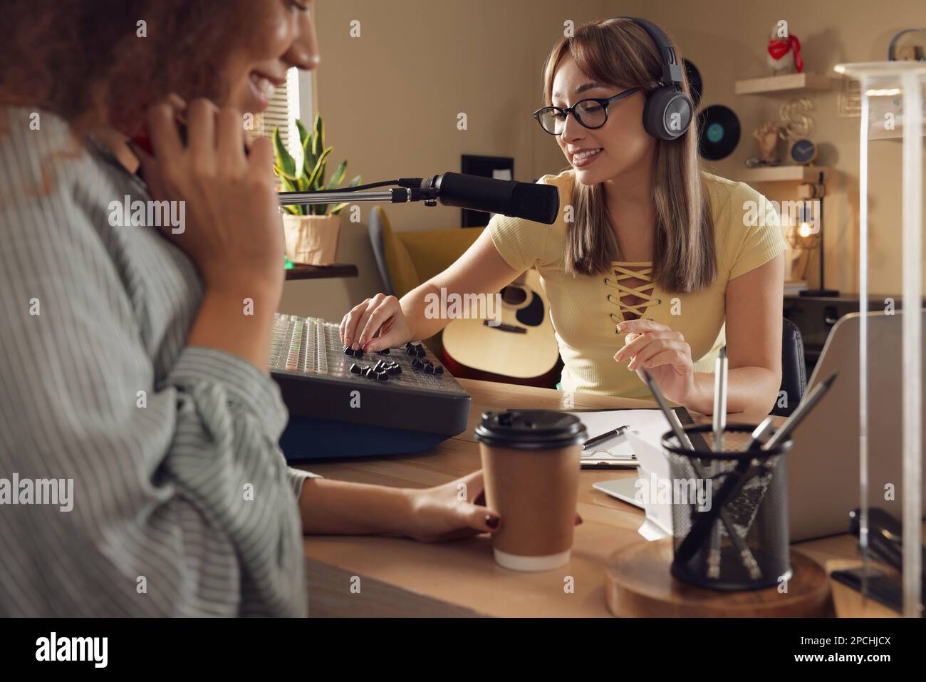 Radio host interviewing young woman in modern studio Stock Photo - Alamy