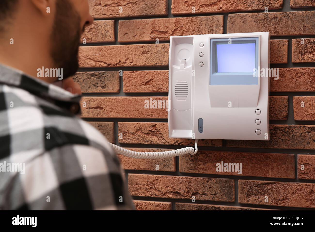 Answering intercom hi-res stock photography and images - Alamy