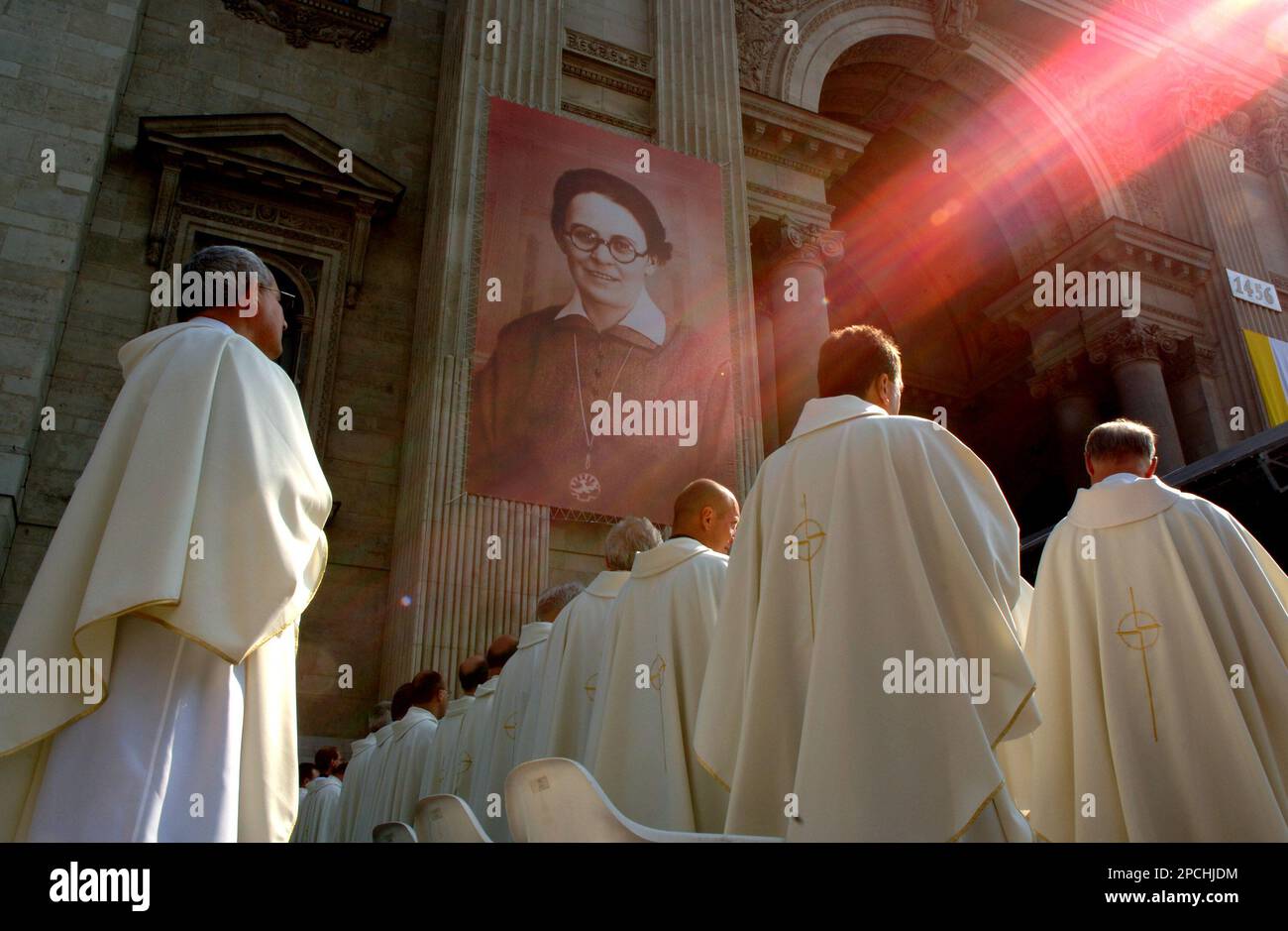 Hungarian priests pray in front of a giant picture showing Hungarian ...