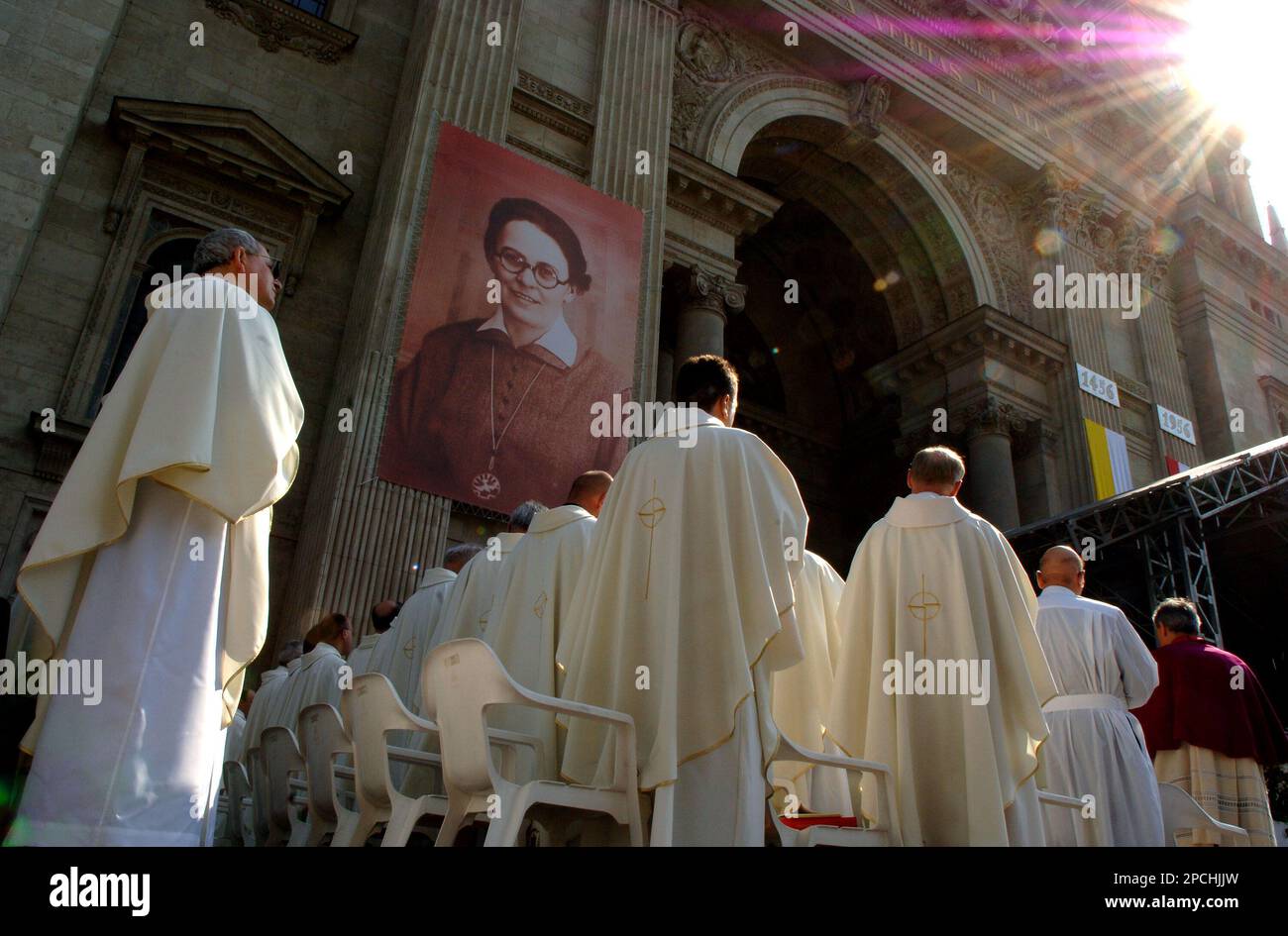 Hungarian priests pray in front of a giant picture showing Hungarian ...