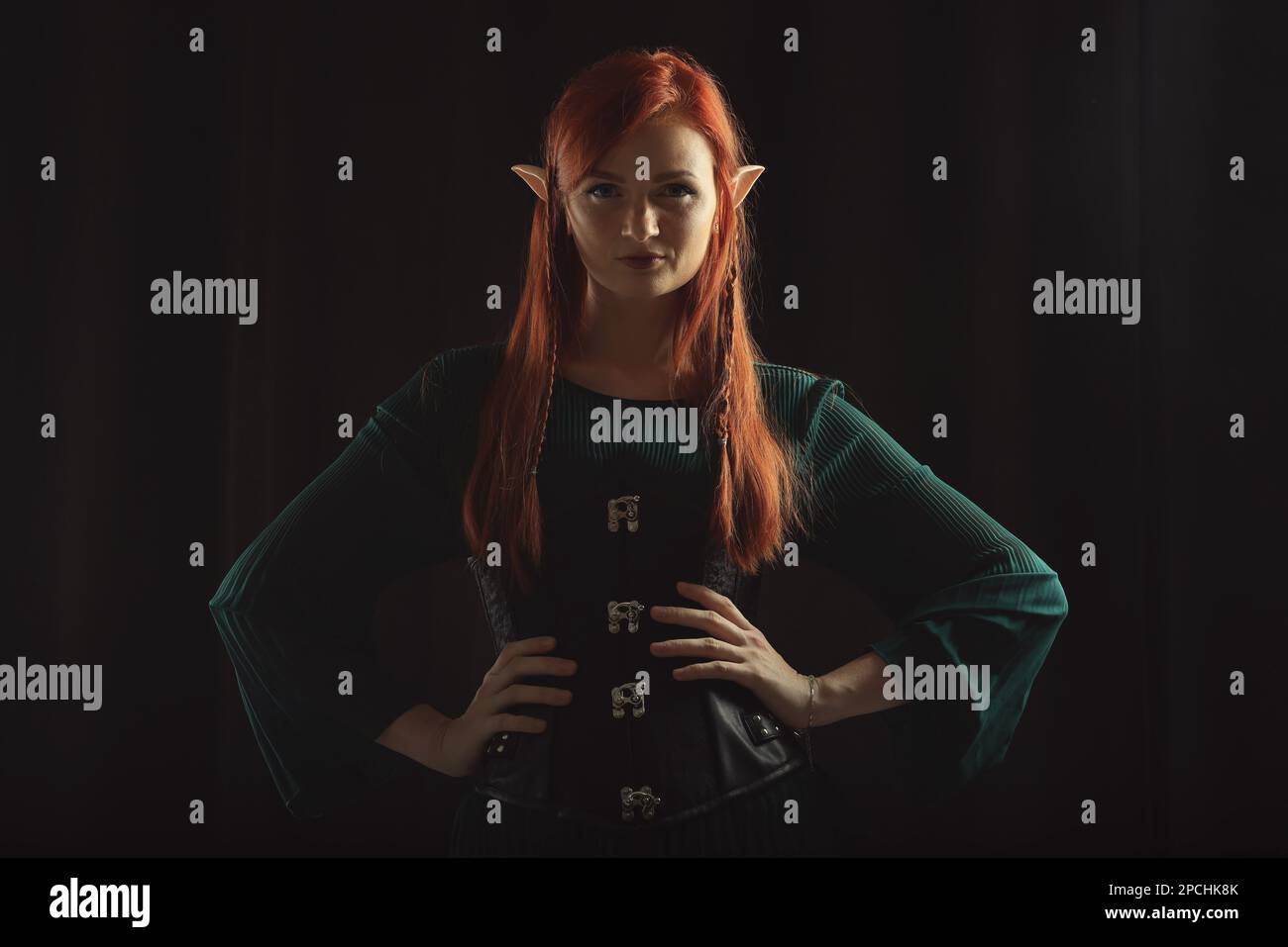 Beautiful redhead elf girl on black background Stock Photo - Alamy