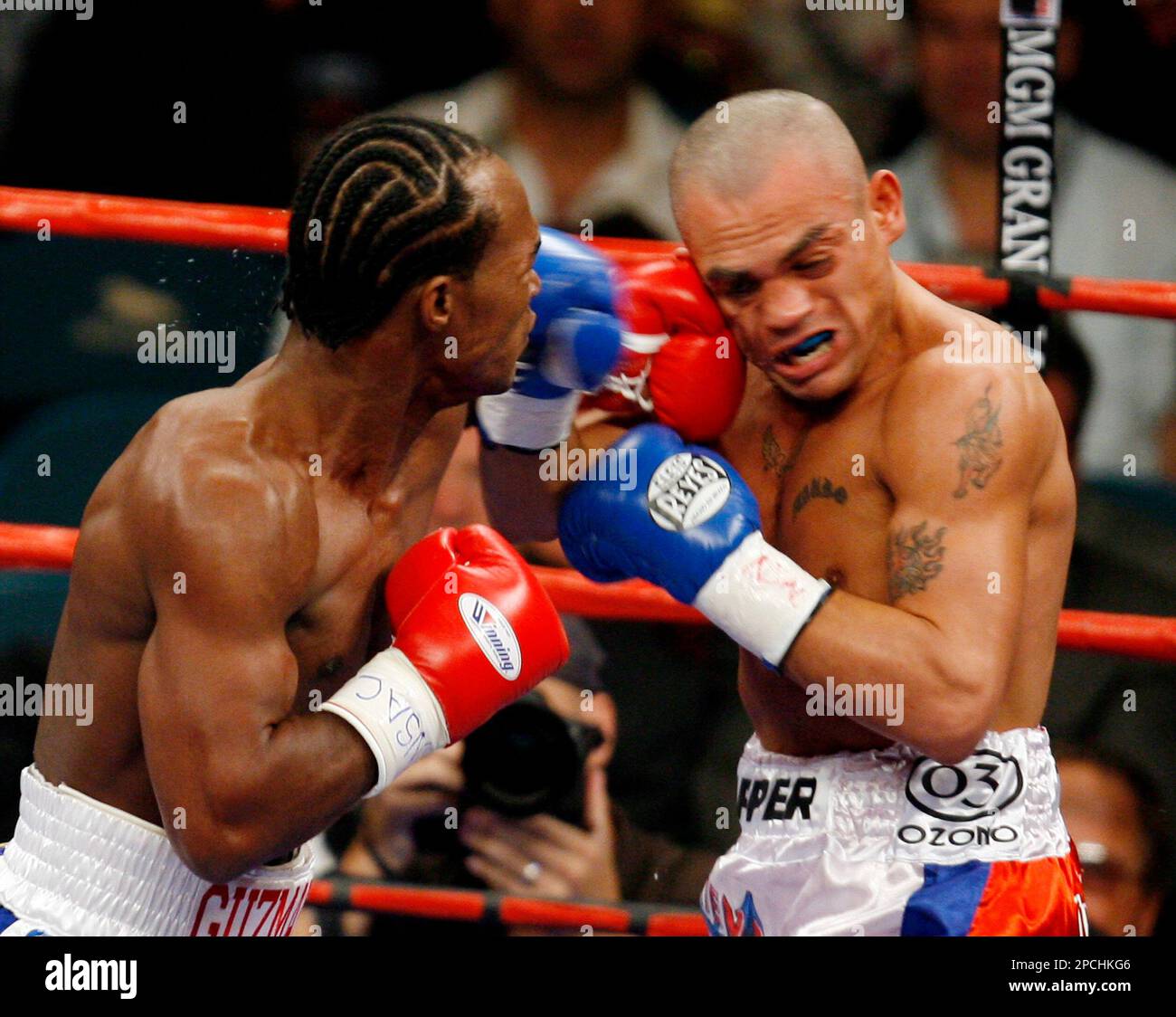 Jorge Rodrigo Barrios, right, of Argentina, takes a punch from Joan ...