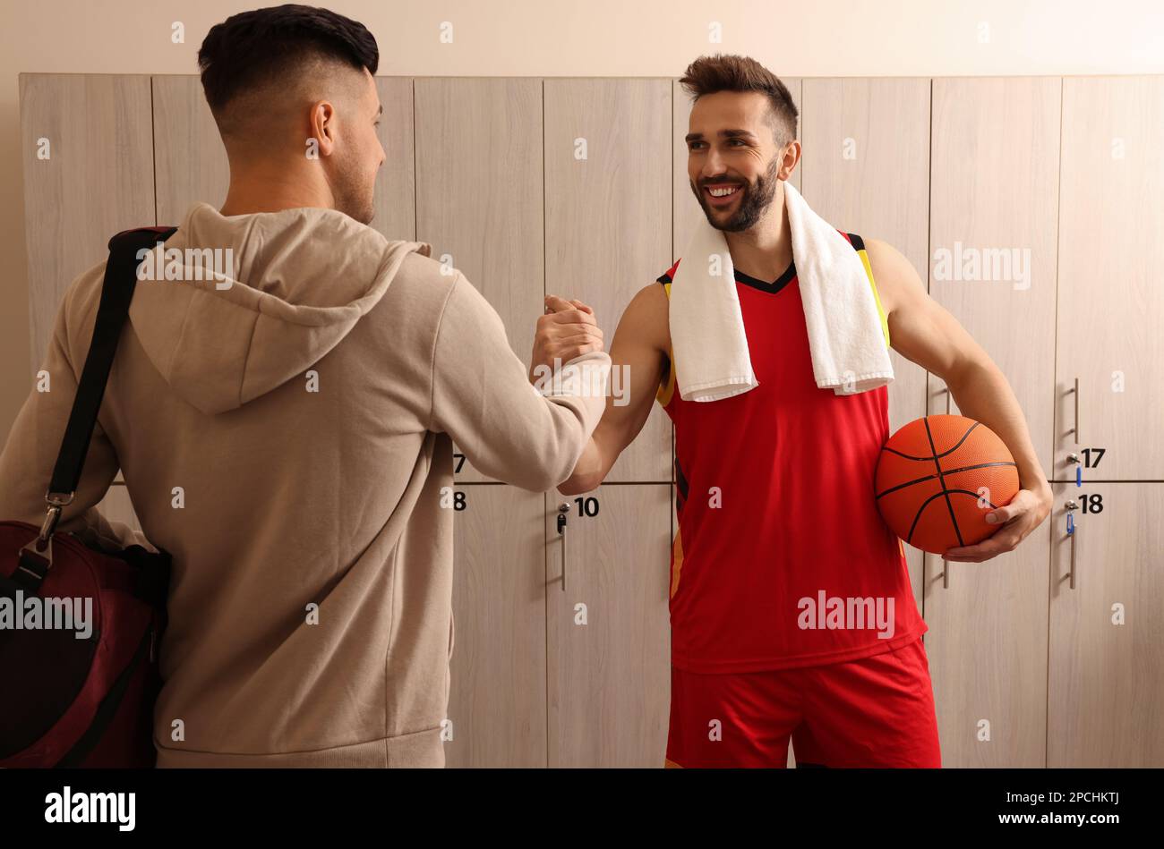 Handsome men greeting each other in locker room Stock Photo - Alamy