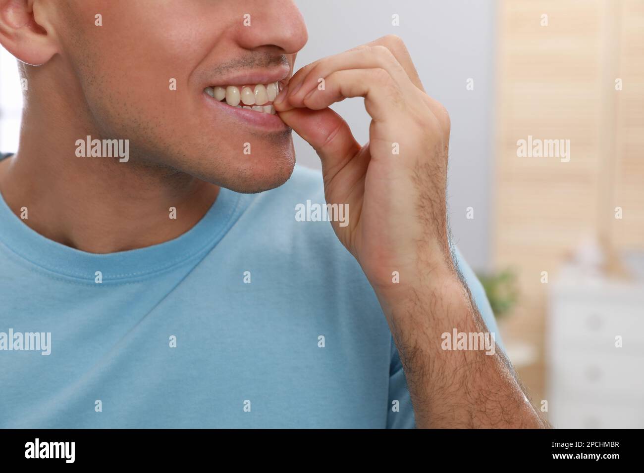 Scared man biting nails hi-res stock photography and images - Alamy