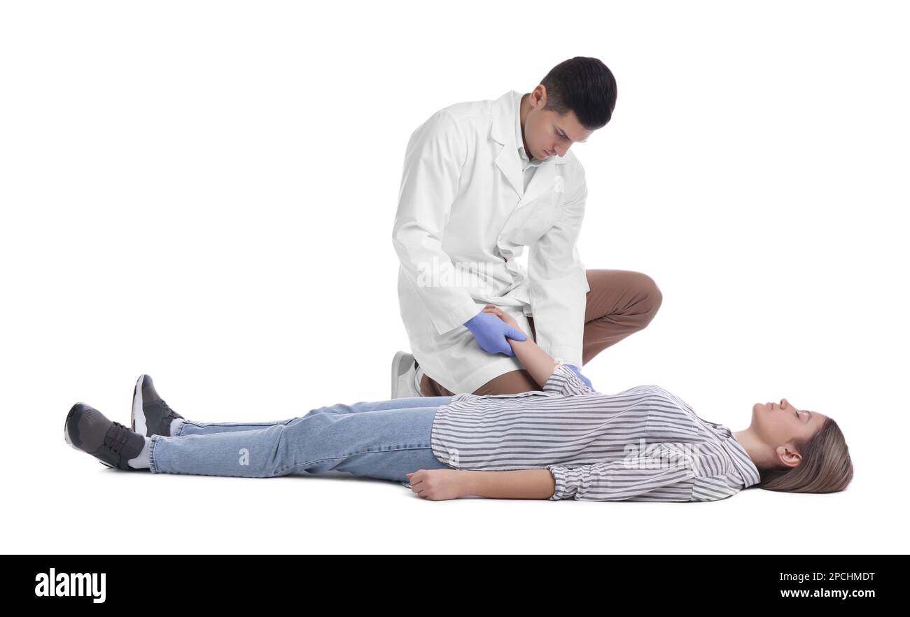 Doctor in uniform practicing first aid on woman against white ...