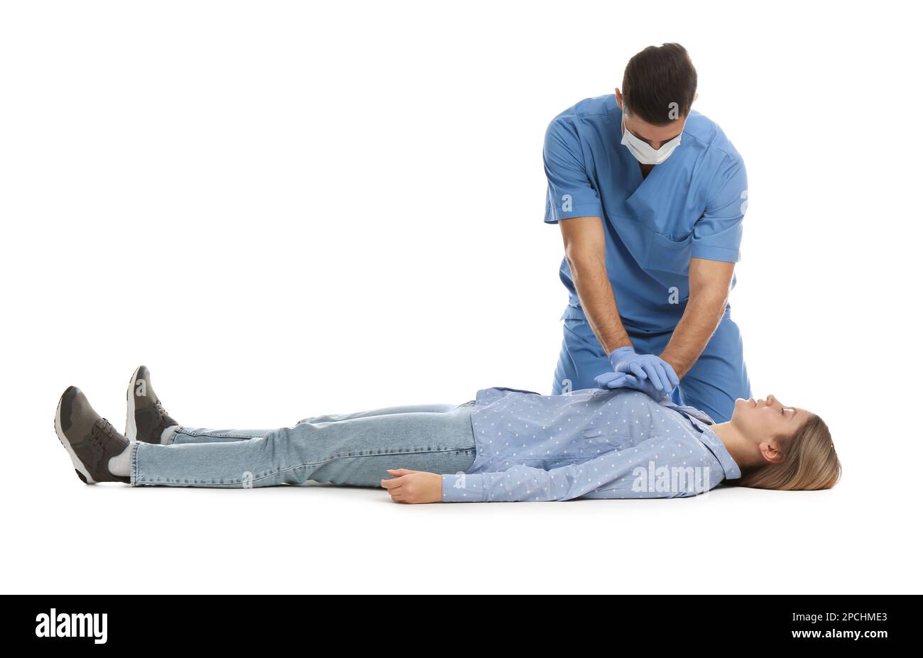 Doctor in uniform practicing first aid on woman against white ...