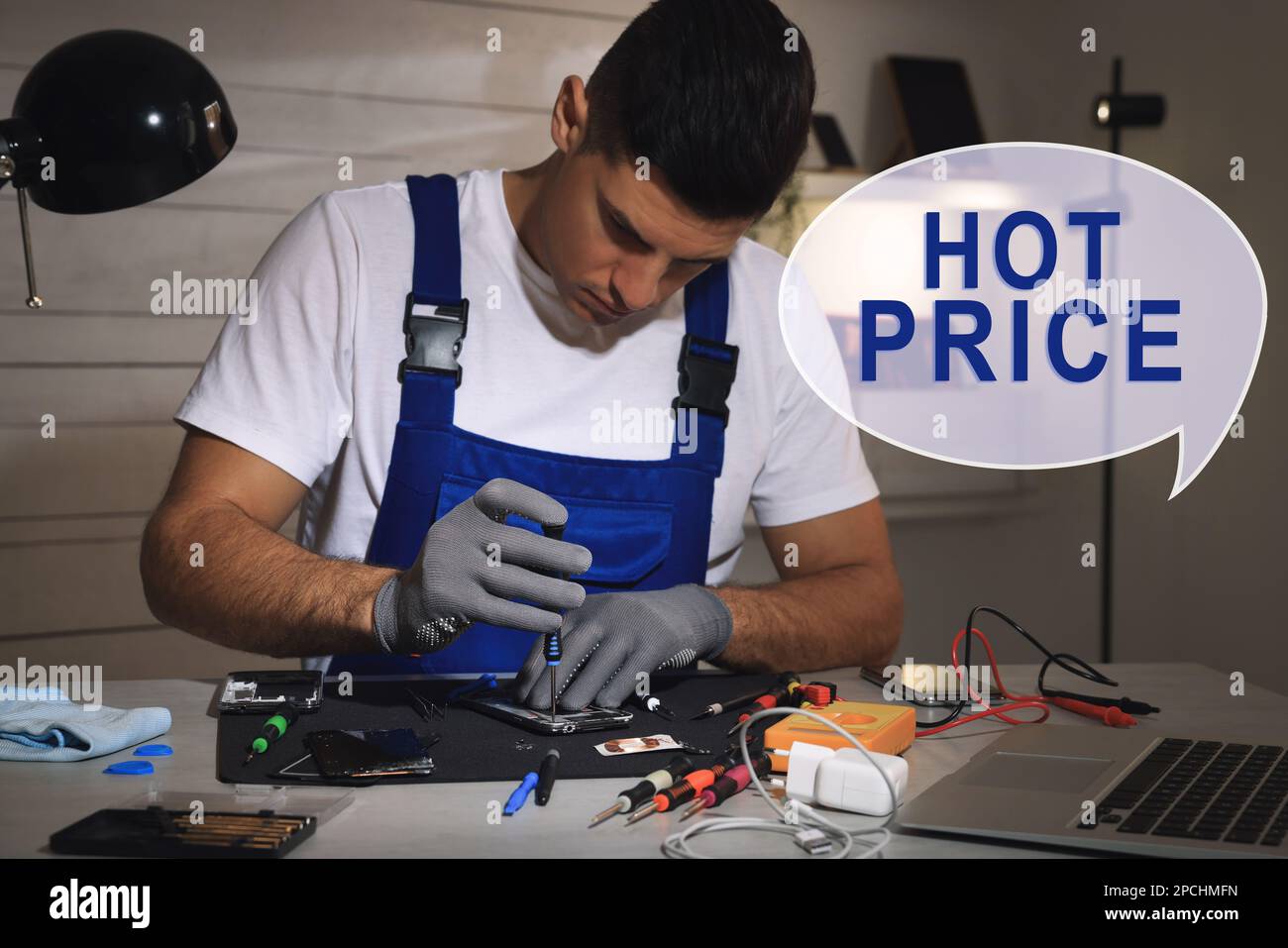 Smartphone repairing by hot price. Man repairing broken mobile at table ...