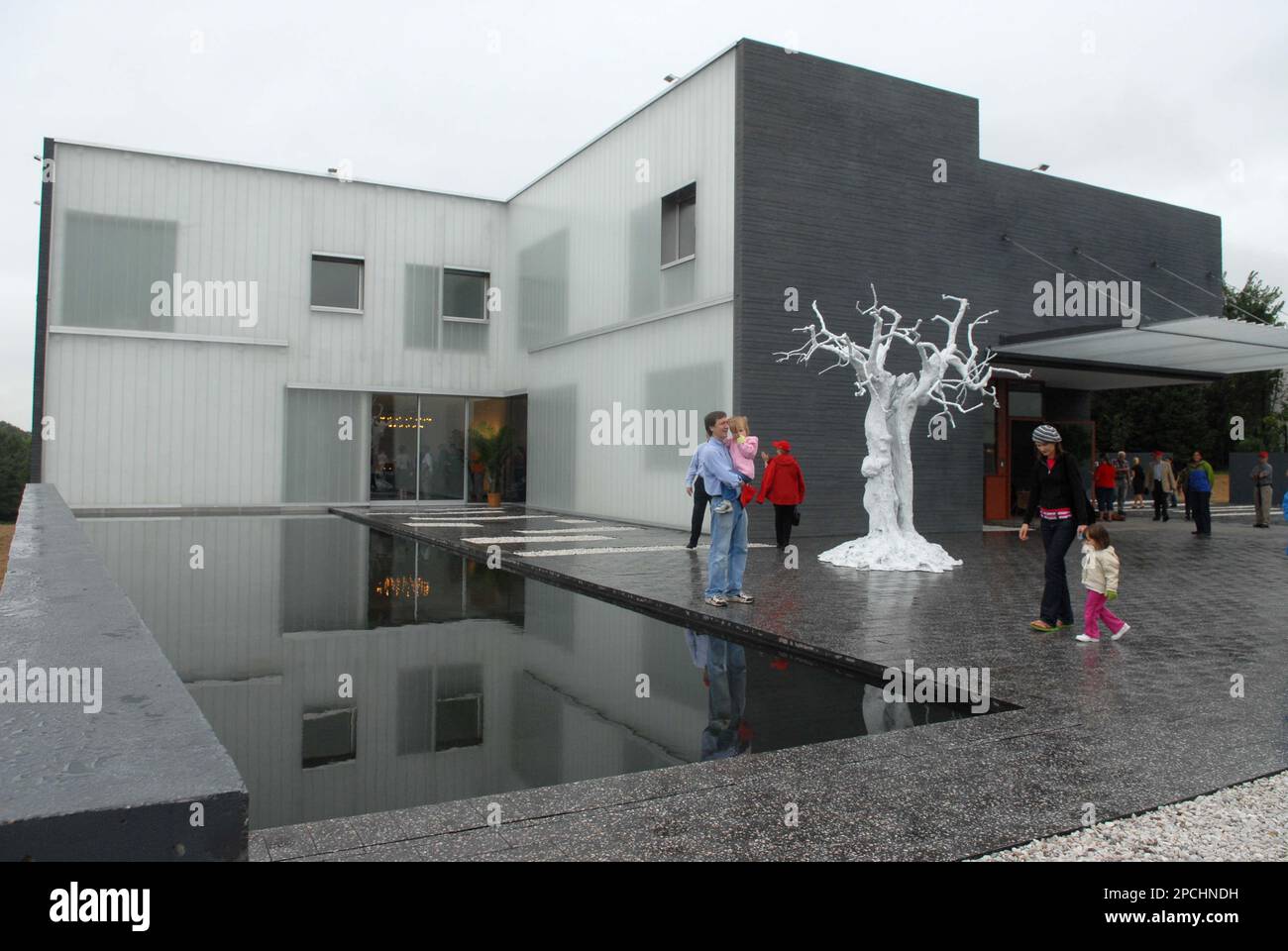 Guests look at the front of the newly-completed Swiss residence ...