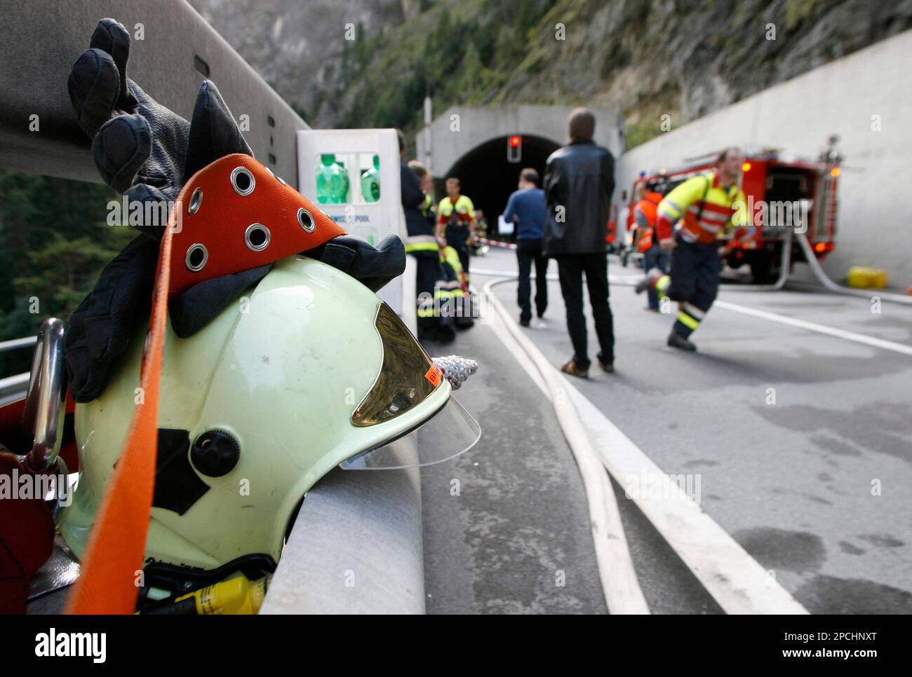 Rescue workers and fire fighters wait in front of the Viamala tunnel on ...