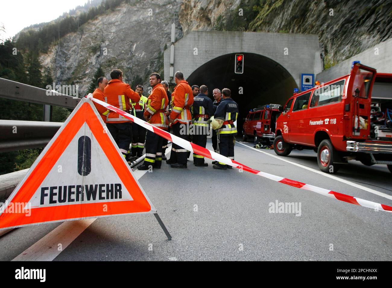 Rescue workers and fire fighters wait in front of the Viamala tunnel on ...