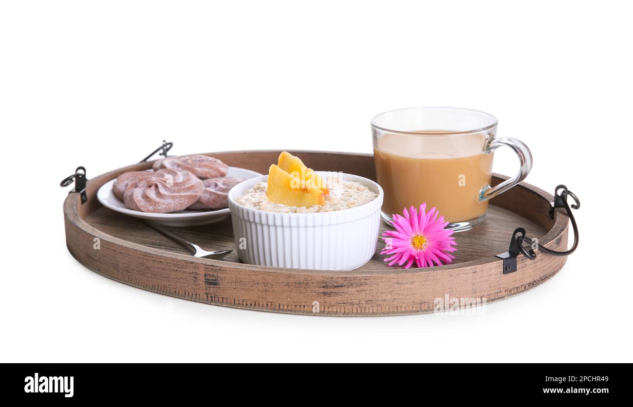 Wooden tray with delicious breakfast and beautiful flower on white ...