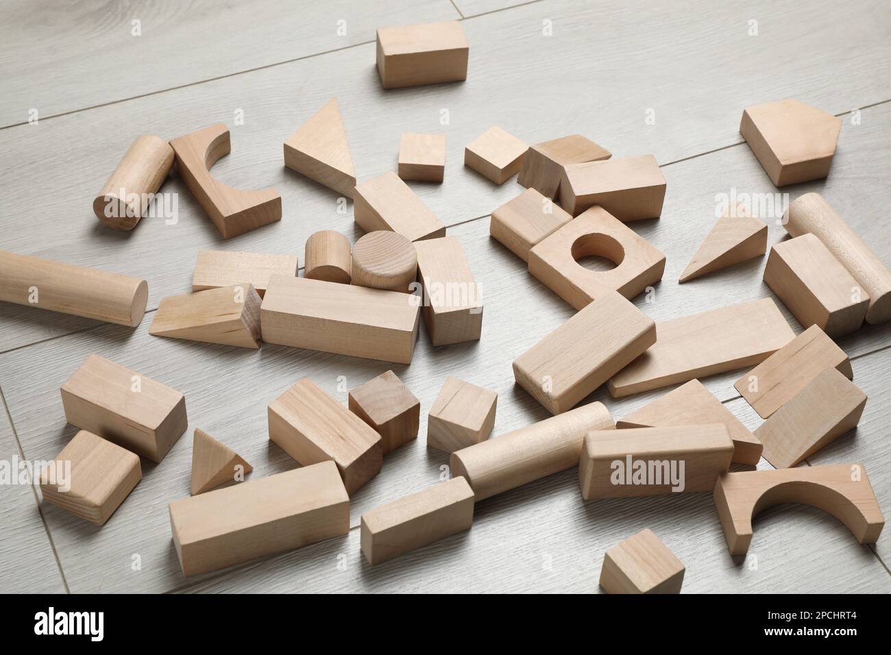 Wooden building blocks set on floor. Child's toy Stock Photo - Alamy