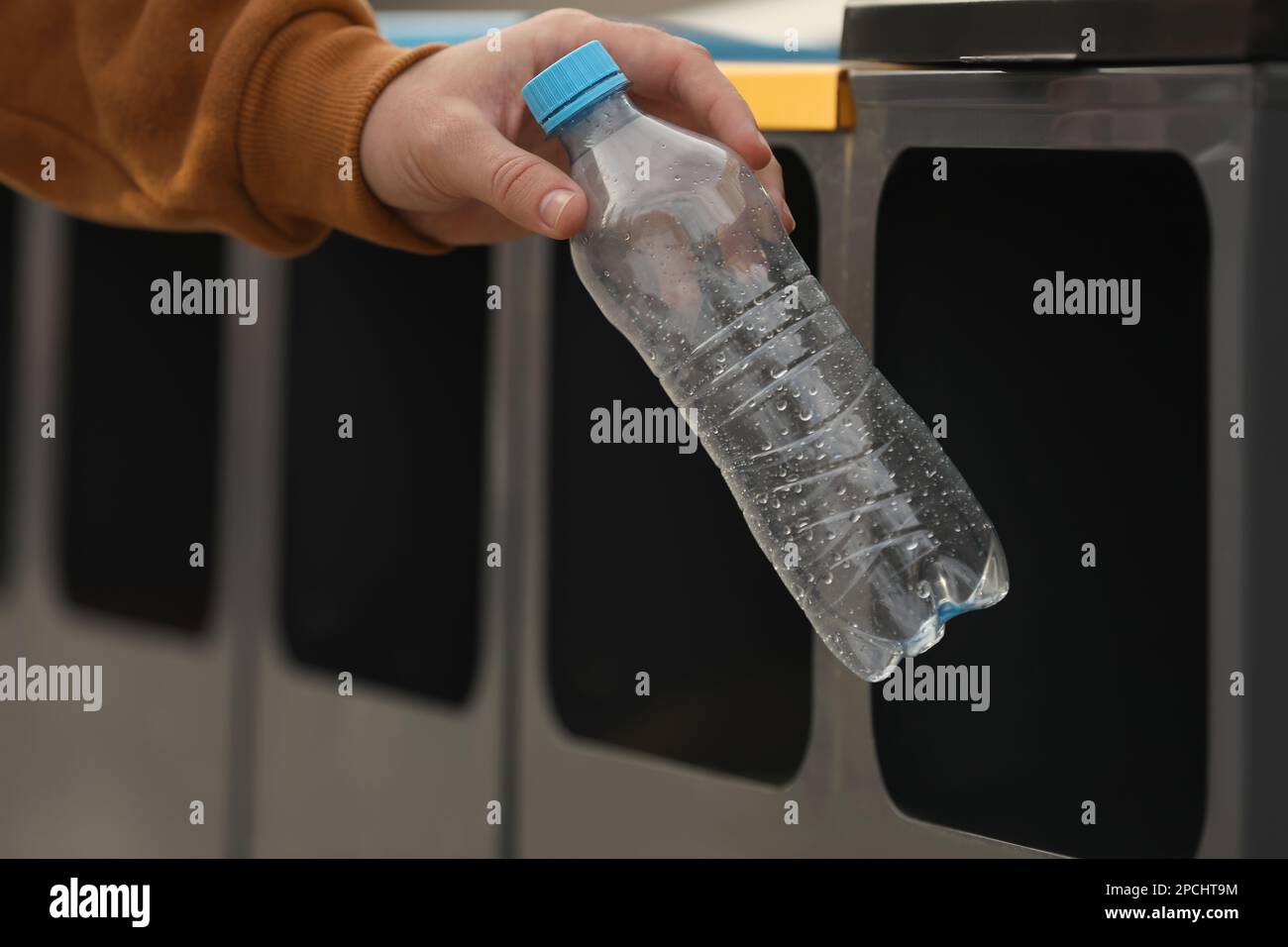 Man throwing plastic bottle into sorting bin, closeup Stock Photo - Alamy