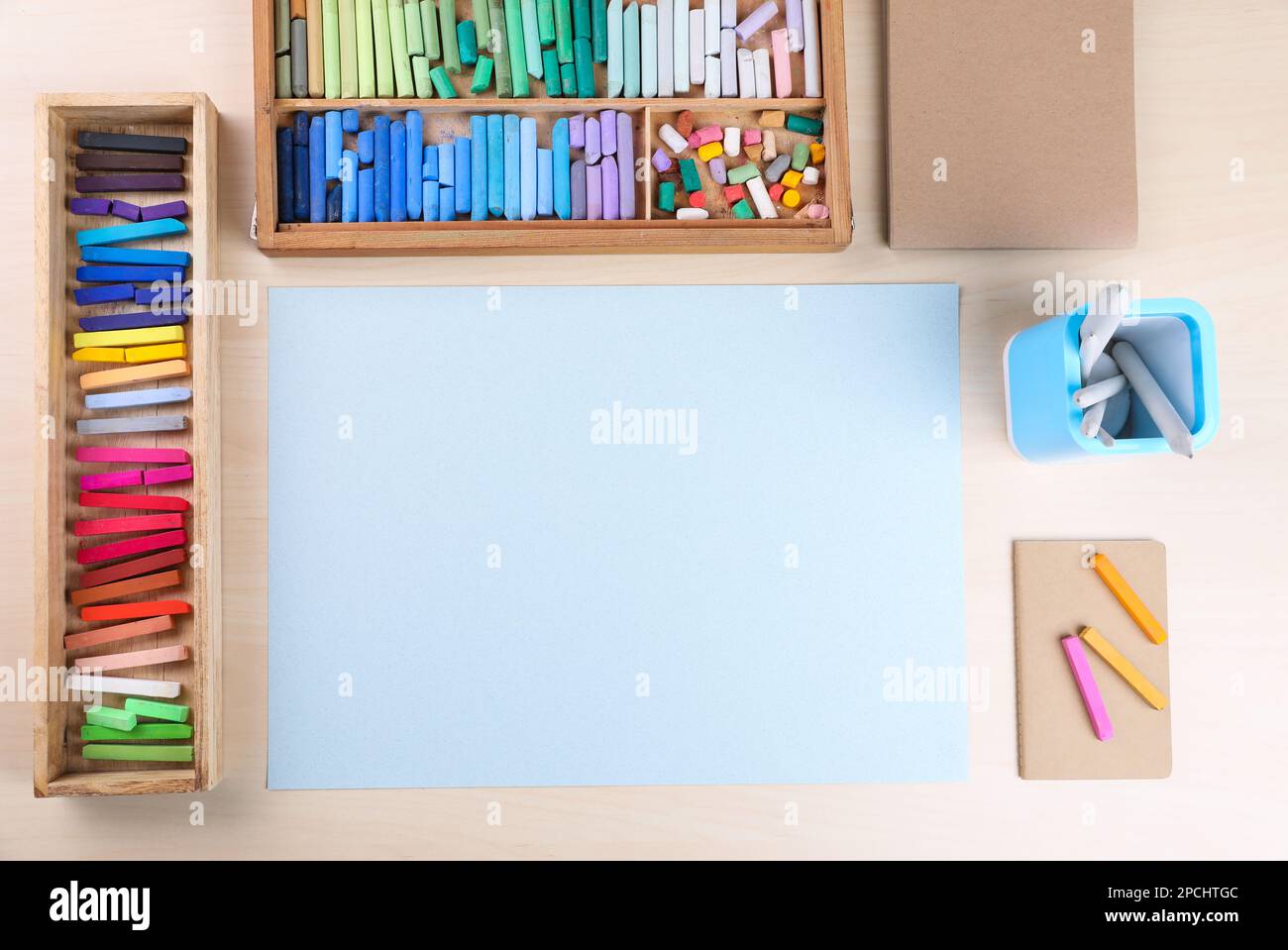 Layout with blank paper, soft pastels and other drawing supplies on ...