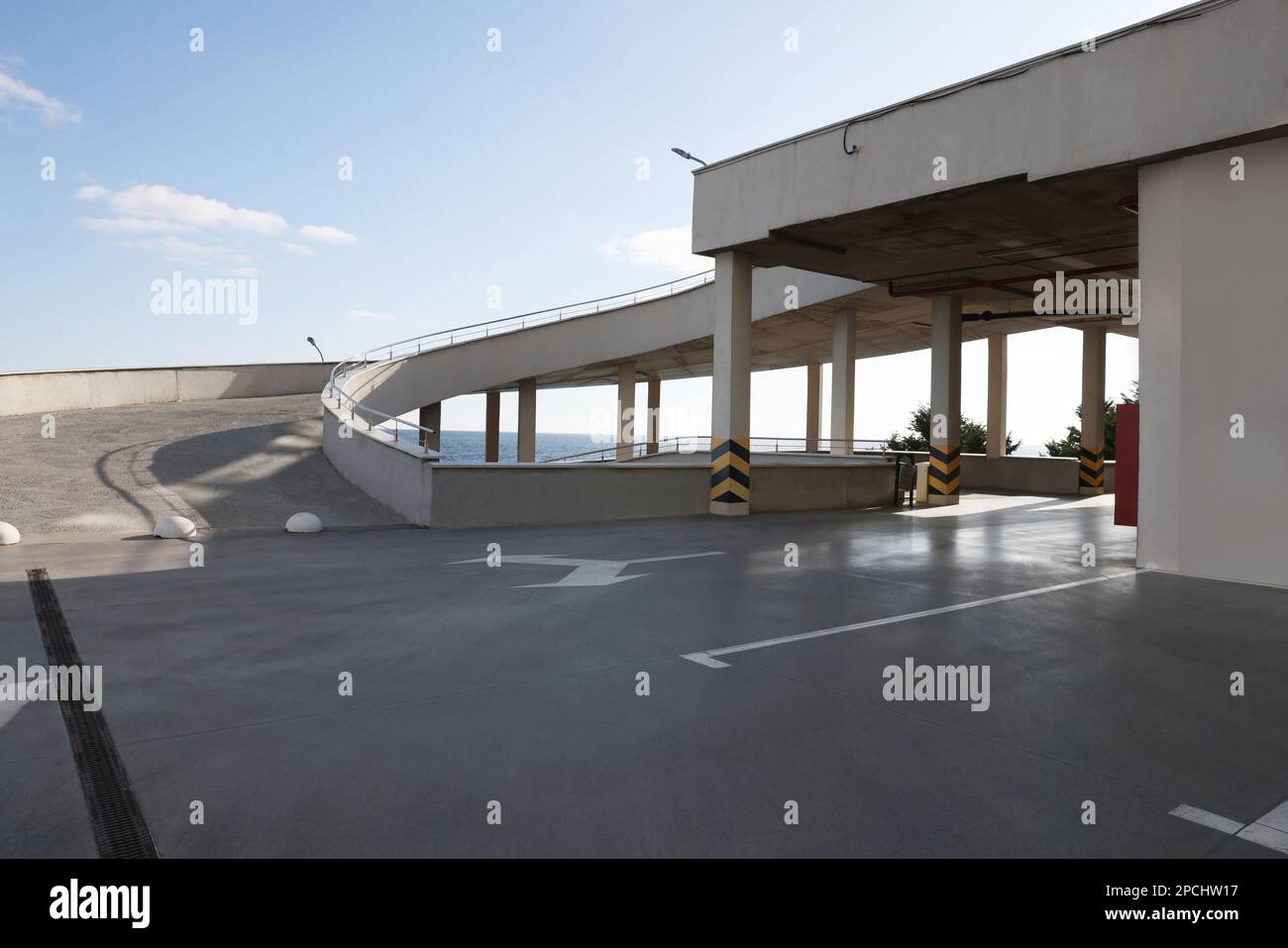 Empty outdoor car parking lot with ramp on sunny day Stock Photo - Alamy