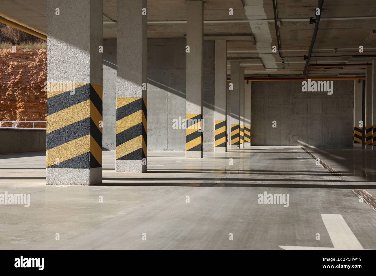 Empty open car parking garage on sunny day Stock Photo - Alamy