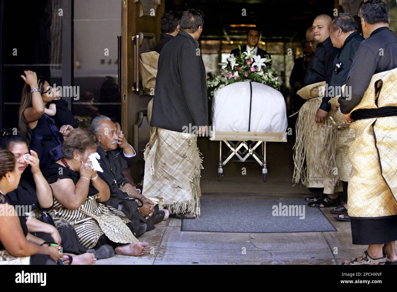 ** FILE ** Tongan mourners watch as the bodies of Tongan Prince Tu ...