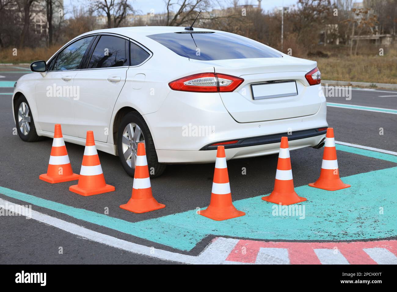 Modern car on driving school test track with traffic cones Stock Photo ...