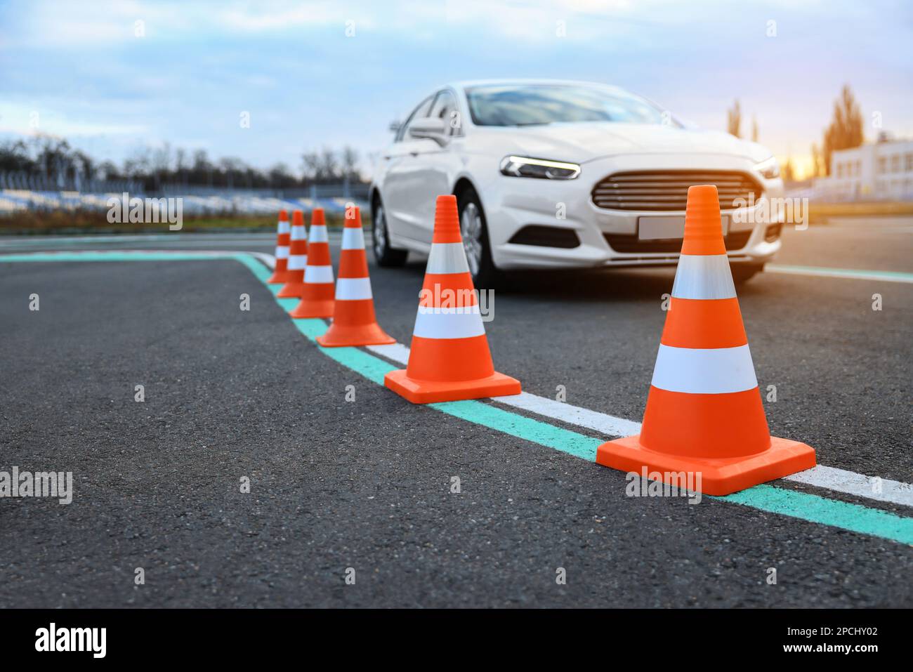 Modern car at test track, focus on traffic cone. Driving school Stock ...