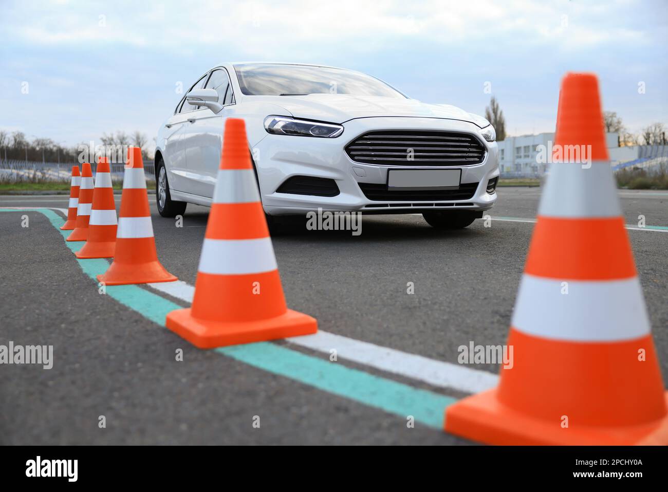 Modern car on test track with traffic cones, low angle view. Driving ...