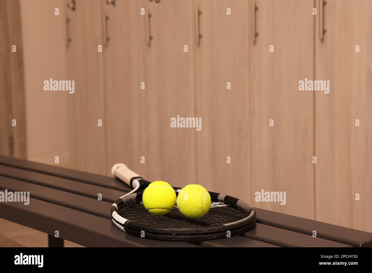 Tennis racket and balls on wooden bench in locker room Stock Photo - Alamy