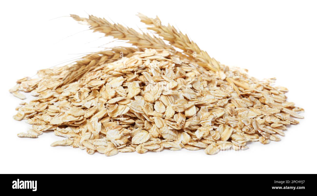 Pile of raw oatmeal and spikelets on white background Stock Photo - Alamy