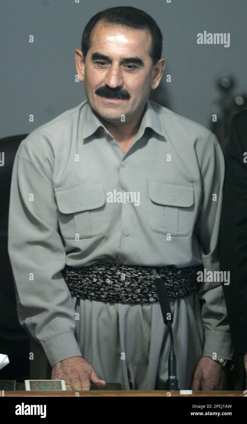 Complainant Ali Mahmood places his hand on a Quran before he testifies ...