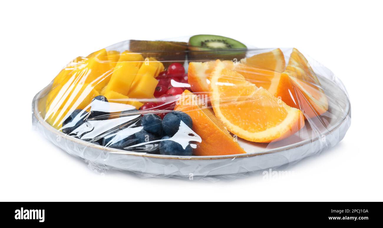 Tray of cut fruits wrapped with transparent plastic stretch film ...