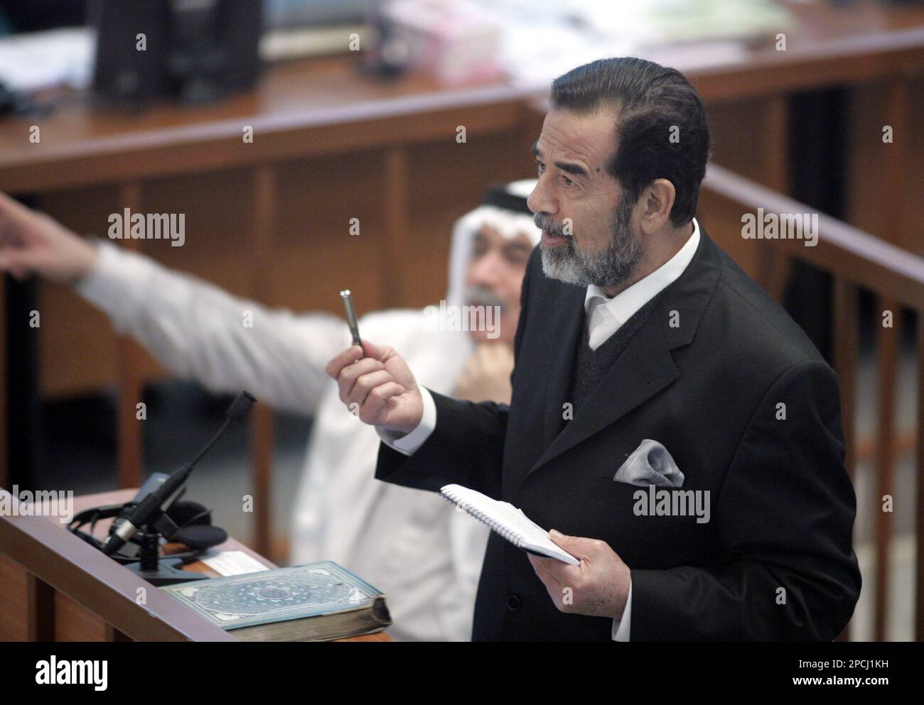 Former Iraqi President Saddam Hussein testifies during his trial on ...