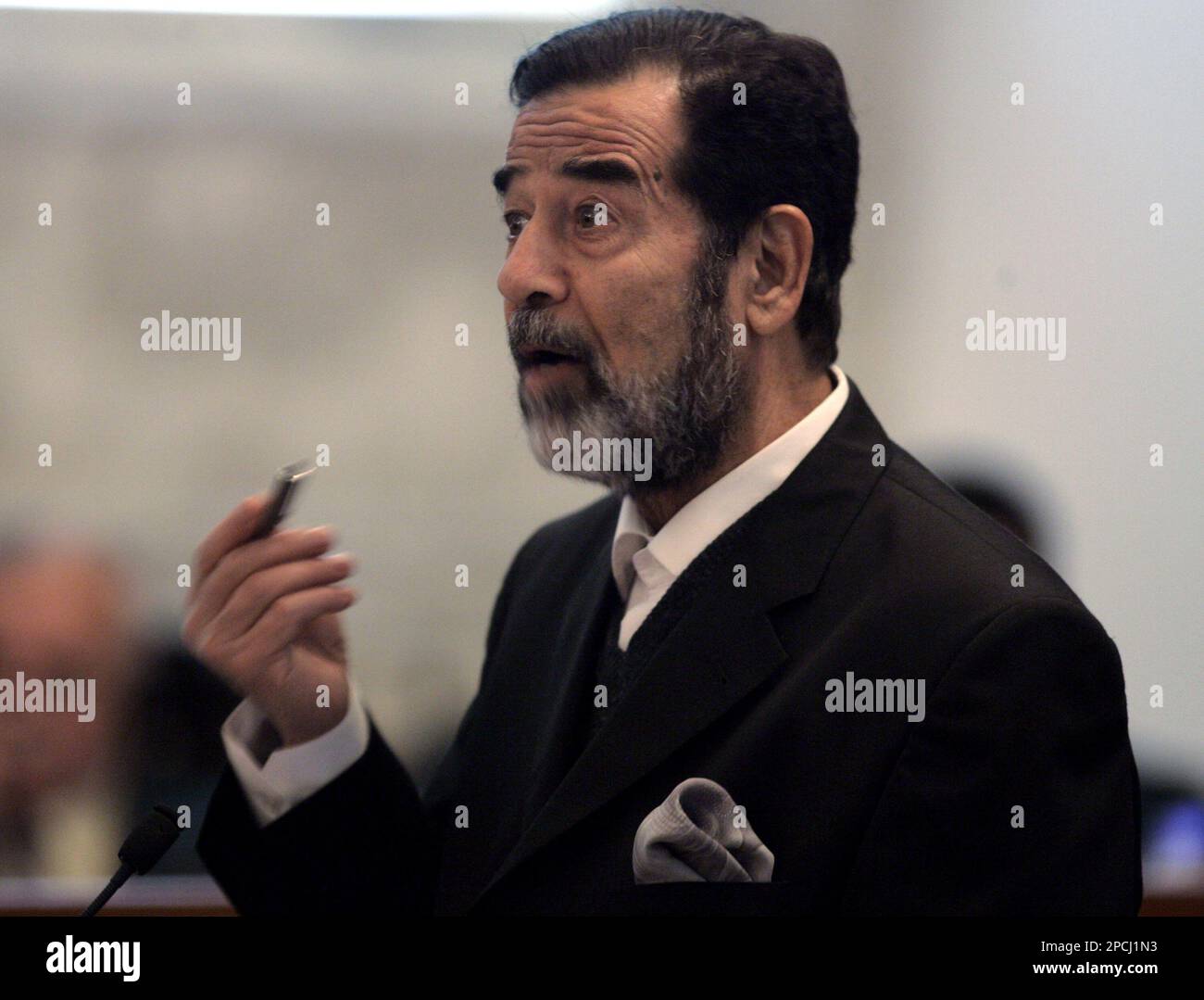 Former Iraqi President Saddam Hussein testifies during his trial on ...