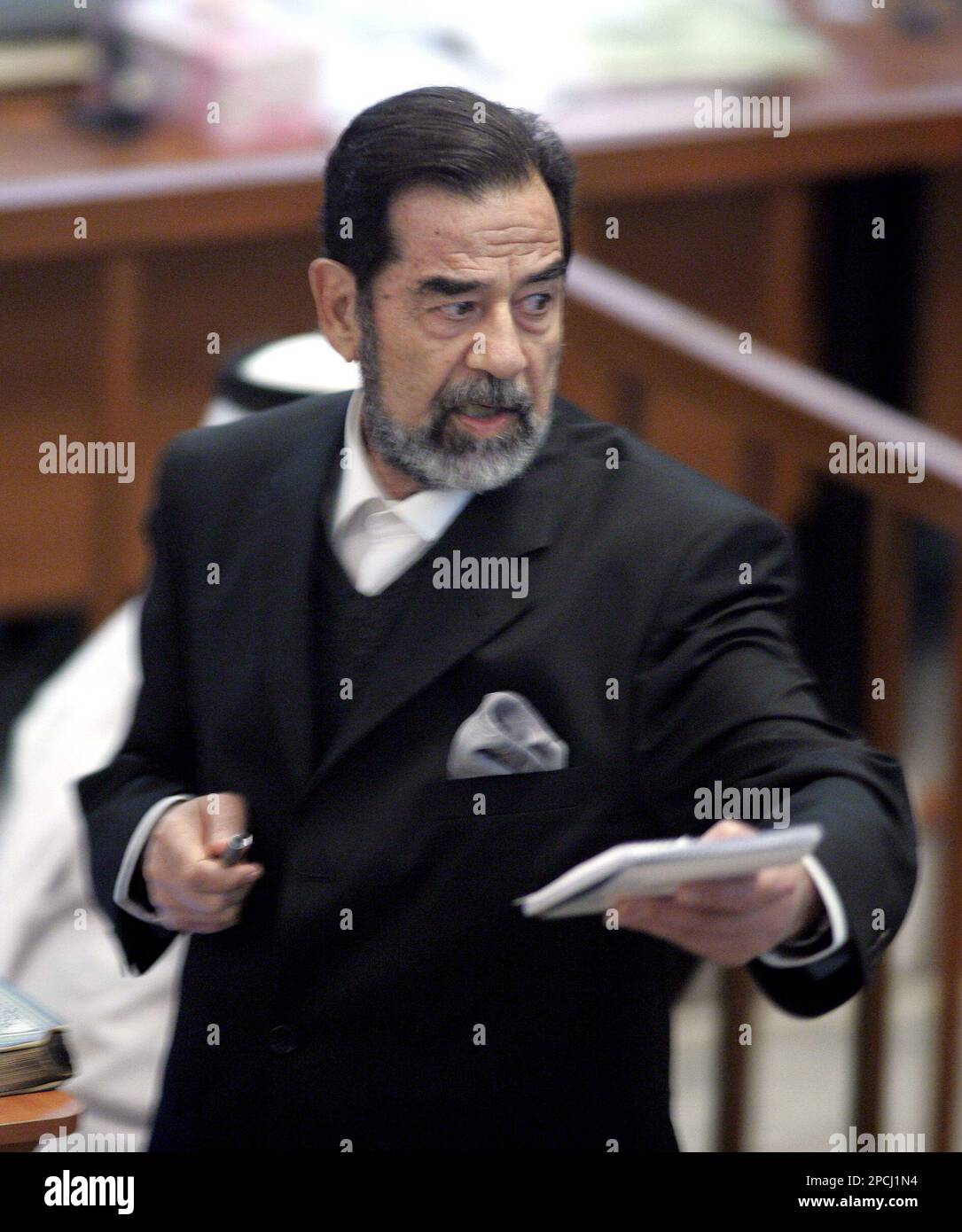 Former Iraqi President Saddam Hussein testifies during his trial on ...
