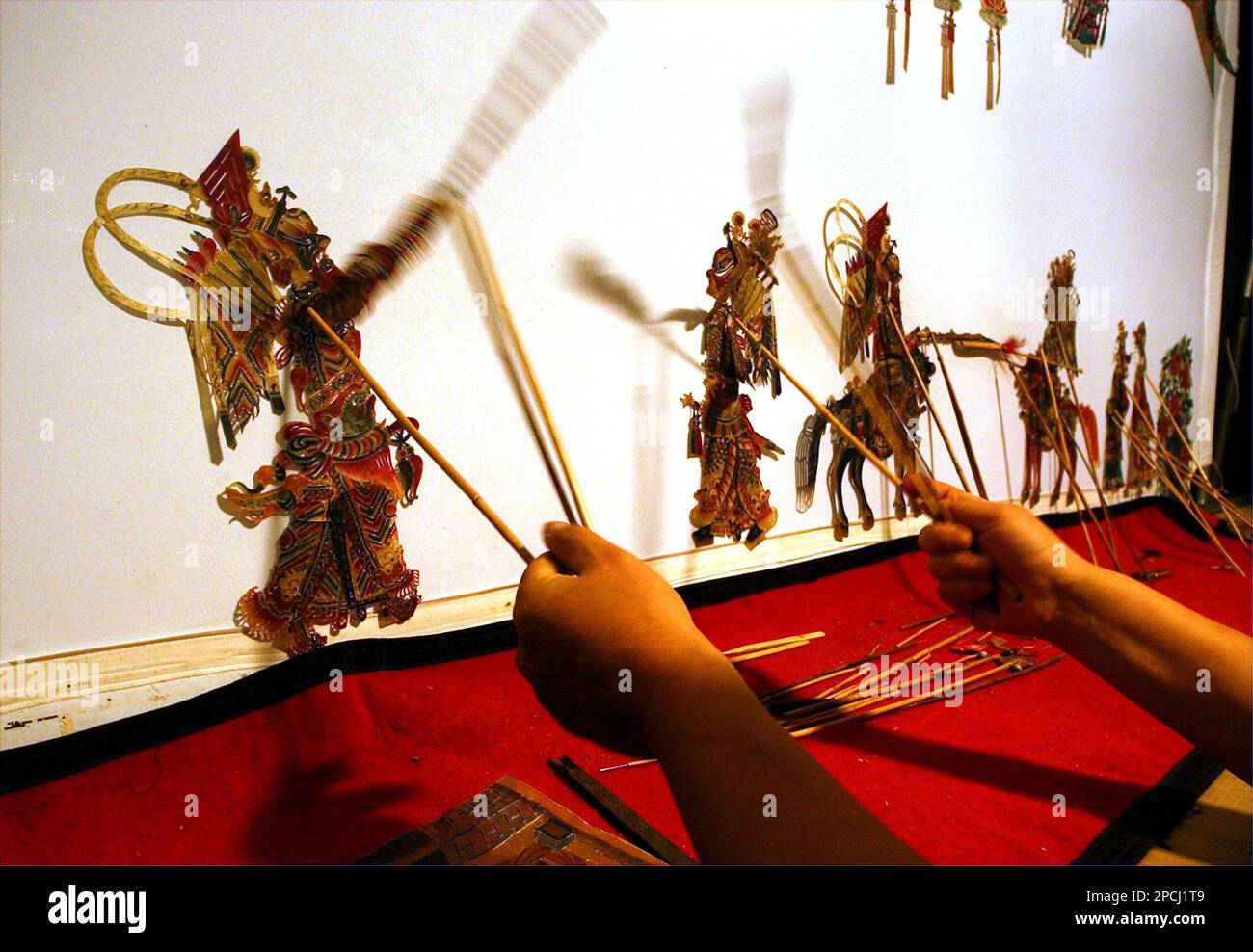 A local folklore artist manipulates Chinese traditional shadow puppets ...