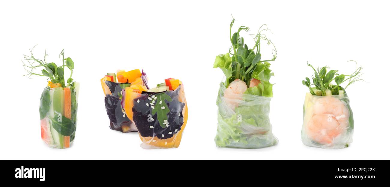 Set with different delicious rolls wrapped in rice paper on white ...