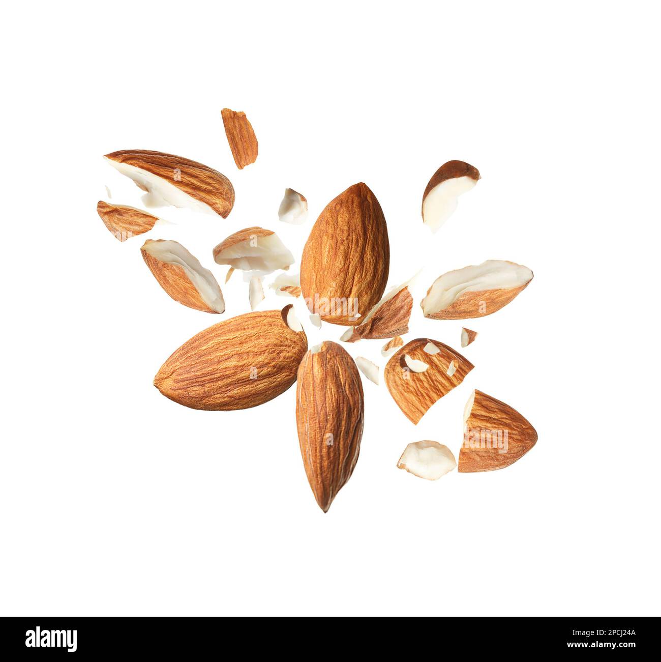 Pieces of tasty almonds falling on white background Stock Photo - Alamy
