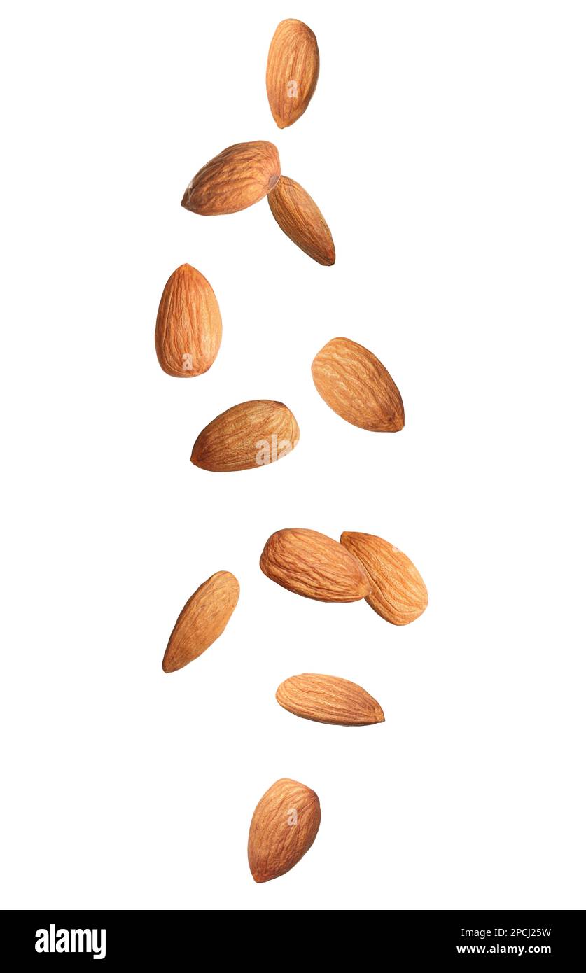 Many tasty almonds falling on white background Stock Photo - Alamy
