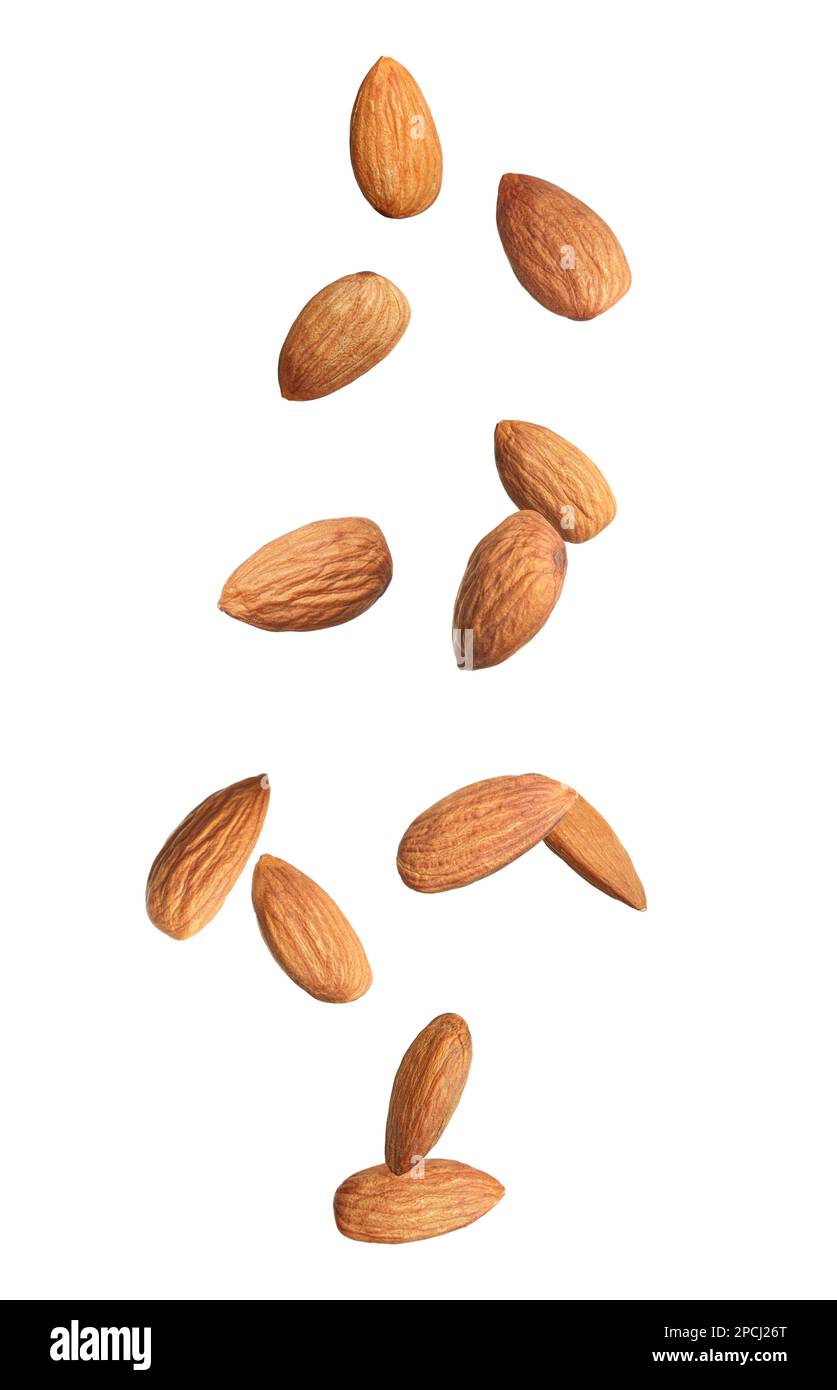 Many tasty almonds falling on white background Stock Photo - Alamy