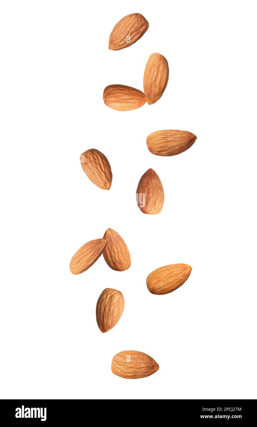 Many tasty almonds falling on white background Stock Photo - Alamy