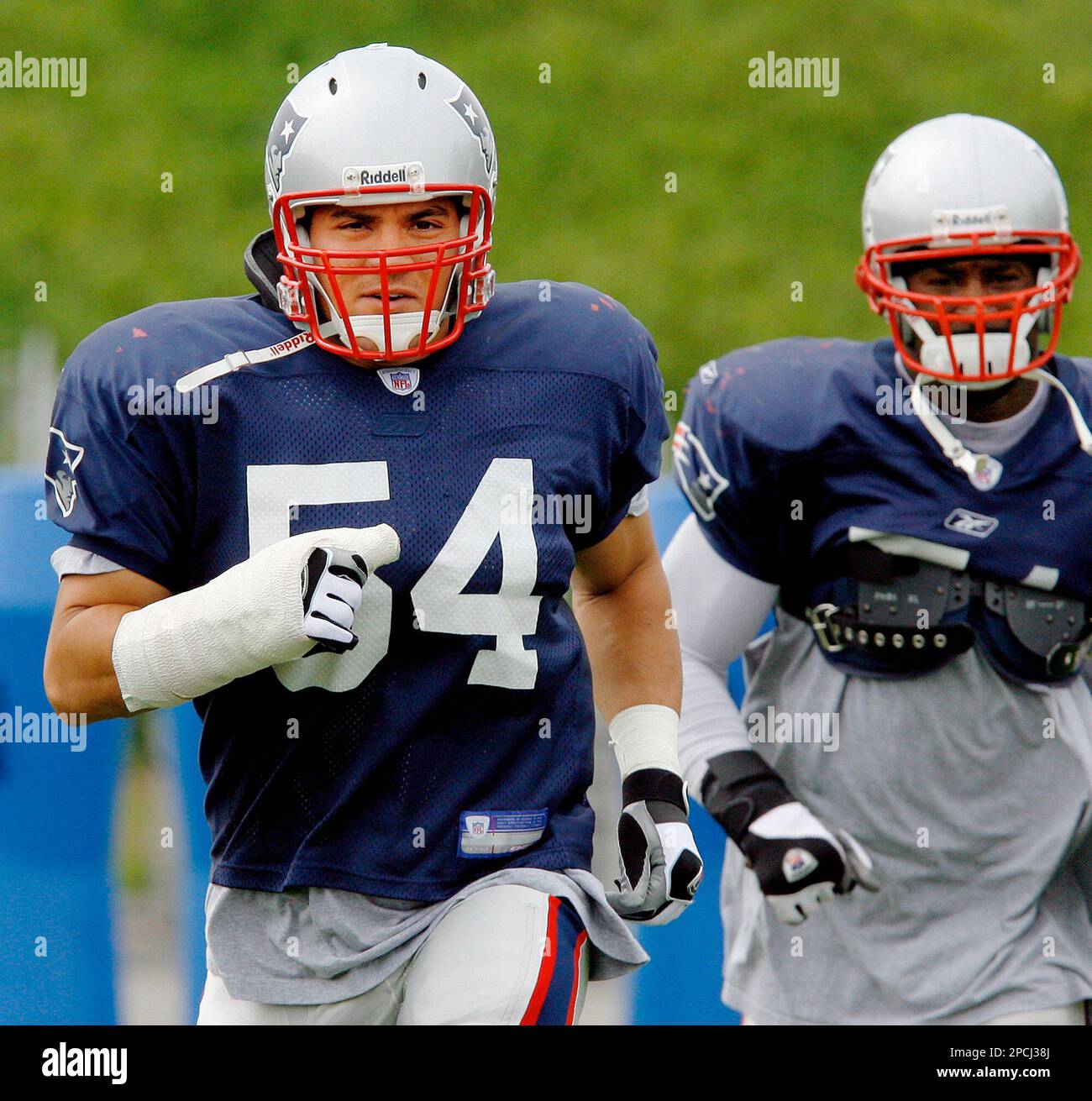New England Patriots linebacker Tedy Bruschi (54) runs, with a cast on ...