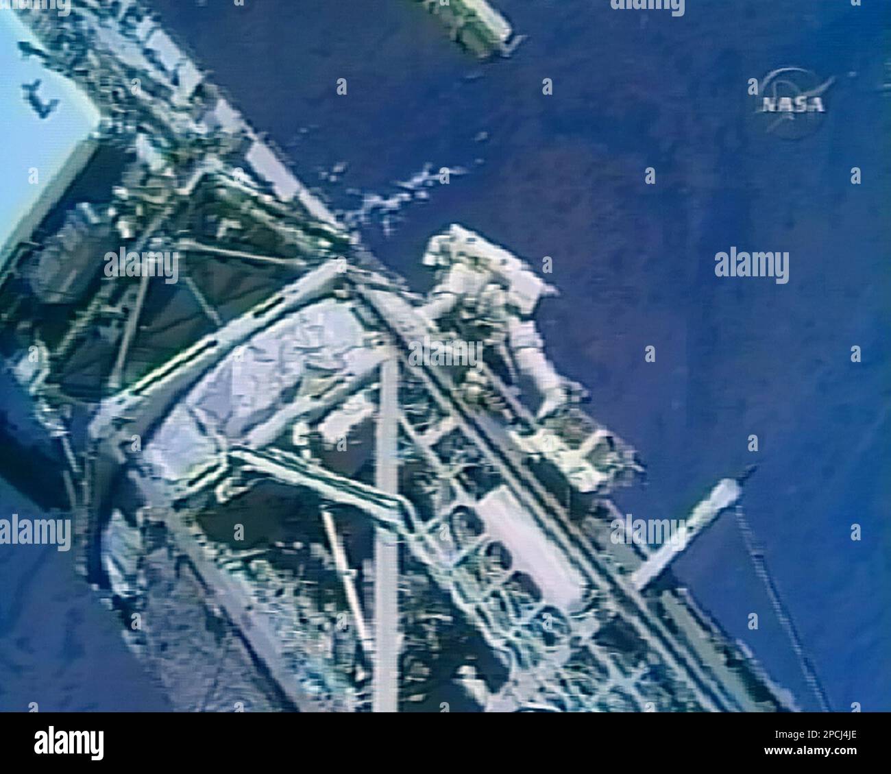 In this image from television Mission Specialist Dan Burbank works on ...