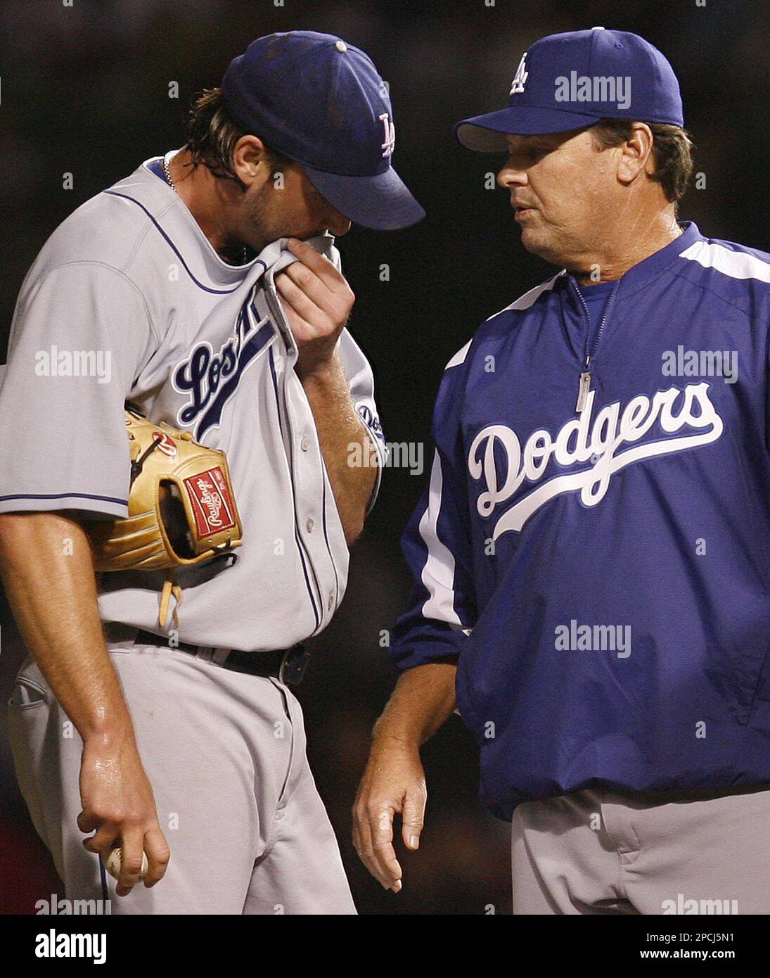Los Angeles Dodgers starting pitcher Derek Lowe, left, looks down as he ...